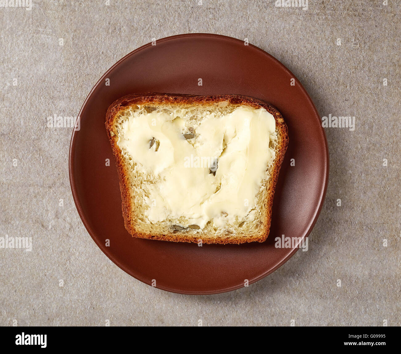 Butter spread on sliced healthy grain bread, top view Stock Photo - Alamy