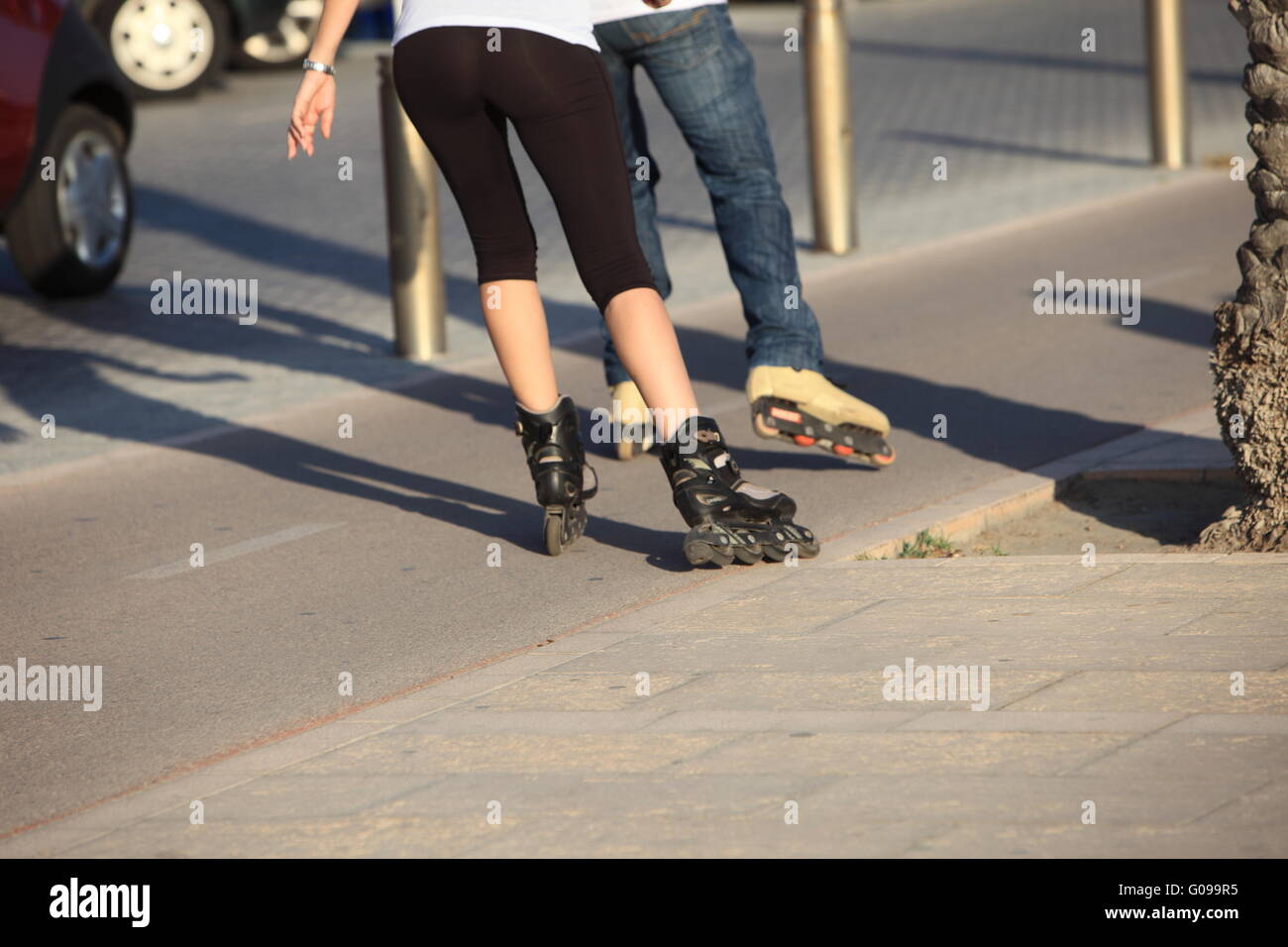 People rollerblading down a sidewalk Stock Photo - Alamy
