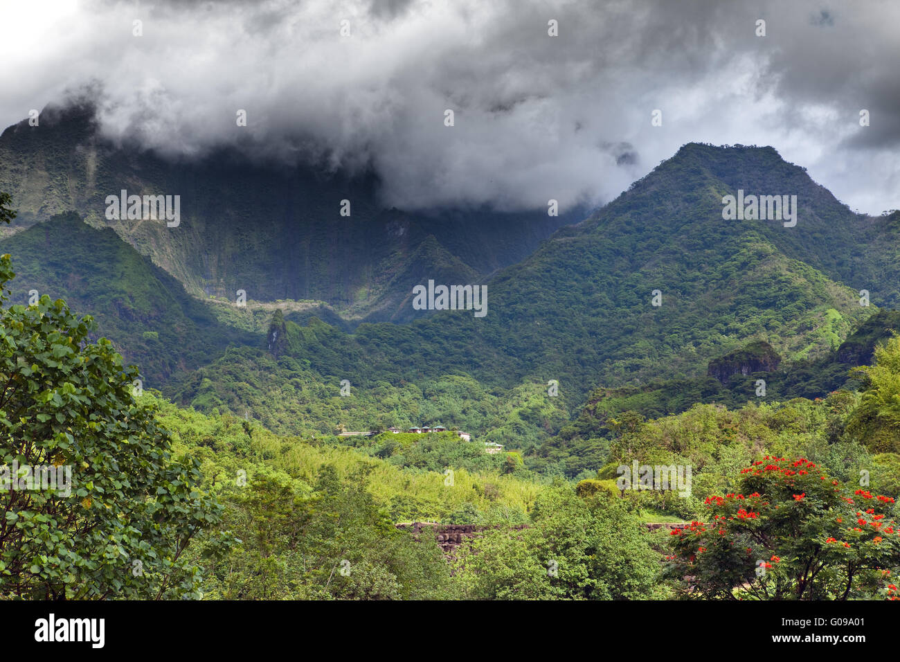 Tahiti. Polynesia. Clouds over a mountain landsca Stock Photo - Alamy