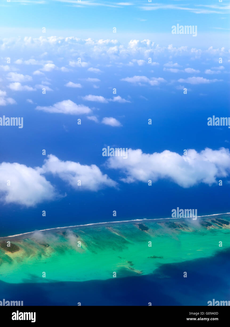 Polynesia. The atoll in ocean through clouds Stock Photo - Alamy