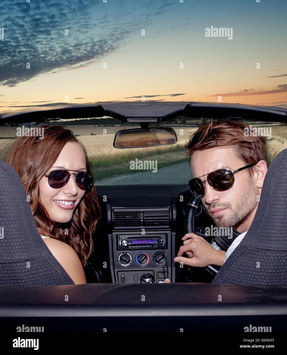 Happy smiling couple in a convertible car. People outdoors Stock Photo ...