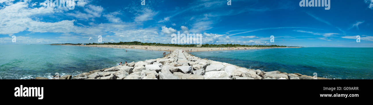 Sandy sea beach panorama view from stony pier Stock Photo - Alamy