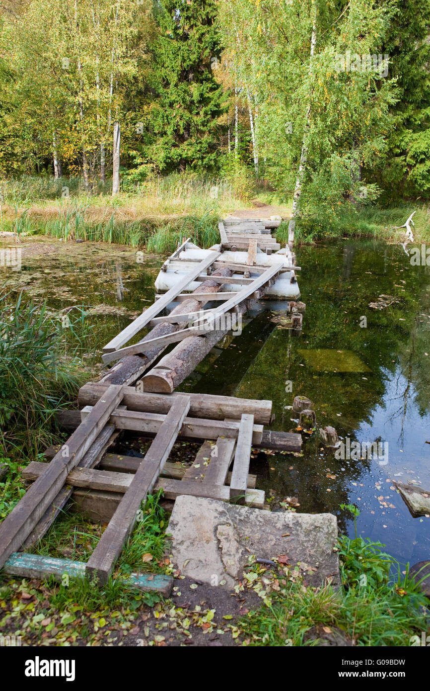 The small shabby bridge in park over a pond Stock Photo - Alamy