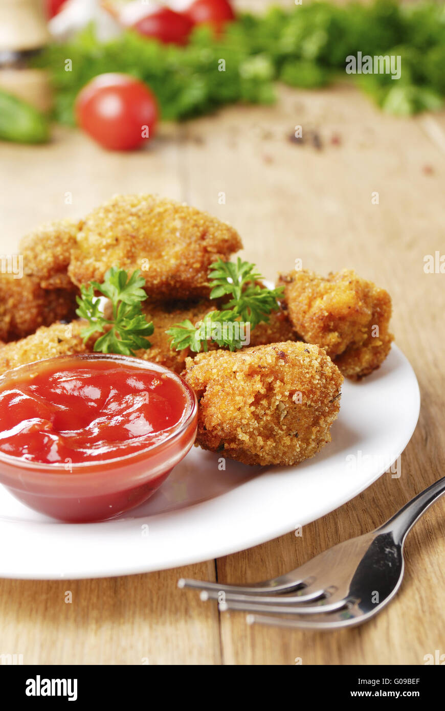Fried chicken nuggets on the plate on the wooden table Stock Photo - Alamy