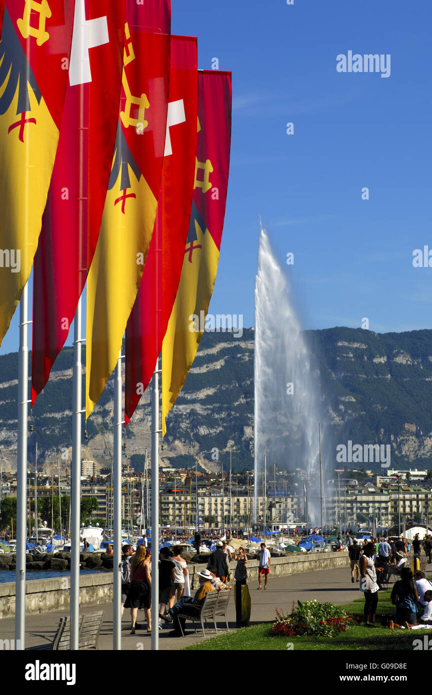 Flags along Lake Geneva with the Jet d'Eau Stock Photo - Alamy