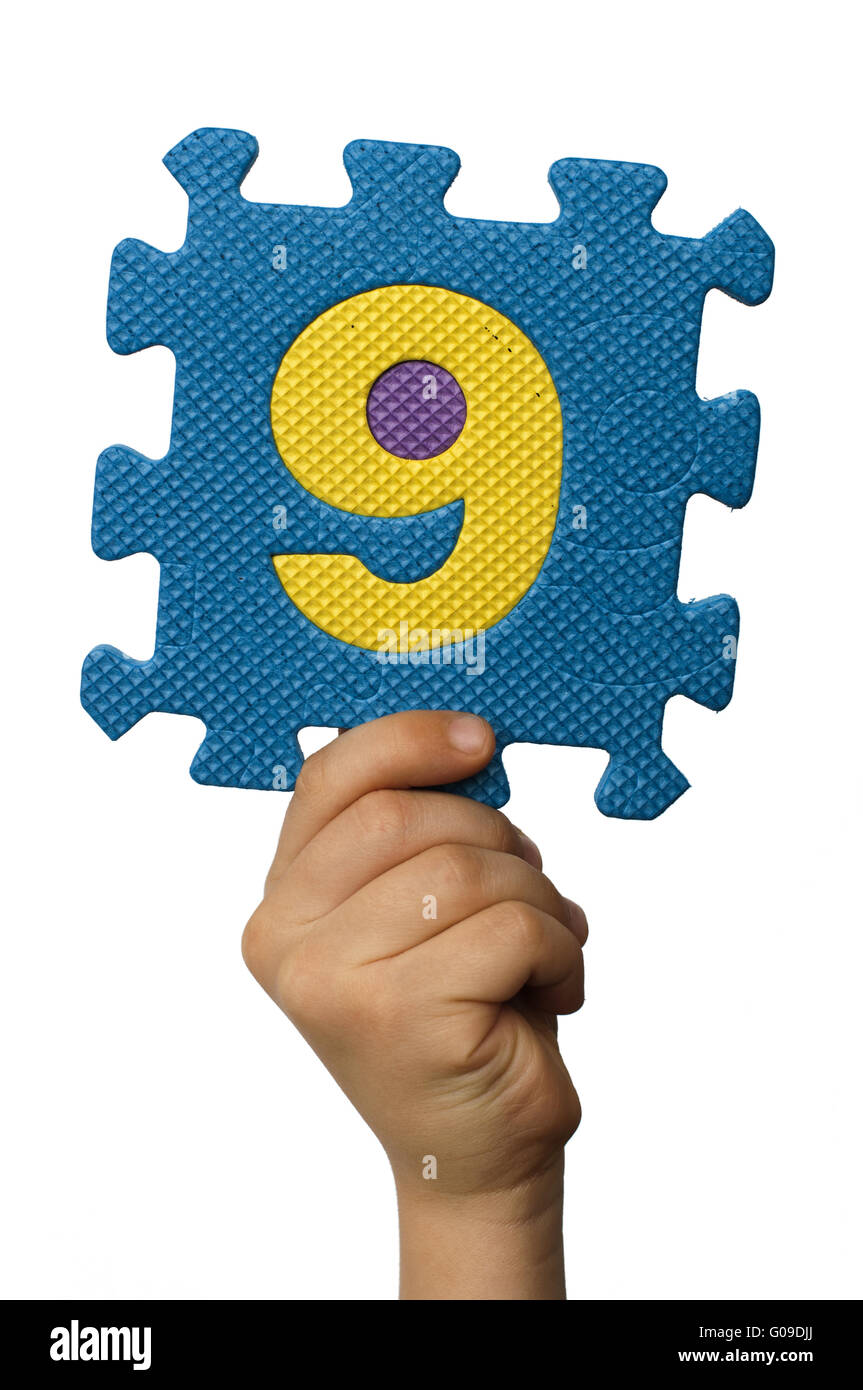 Children hand holding the number Nine. White isolated number Stock ...