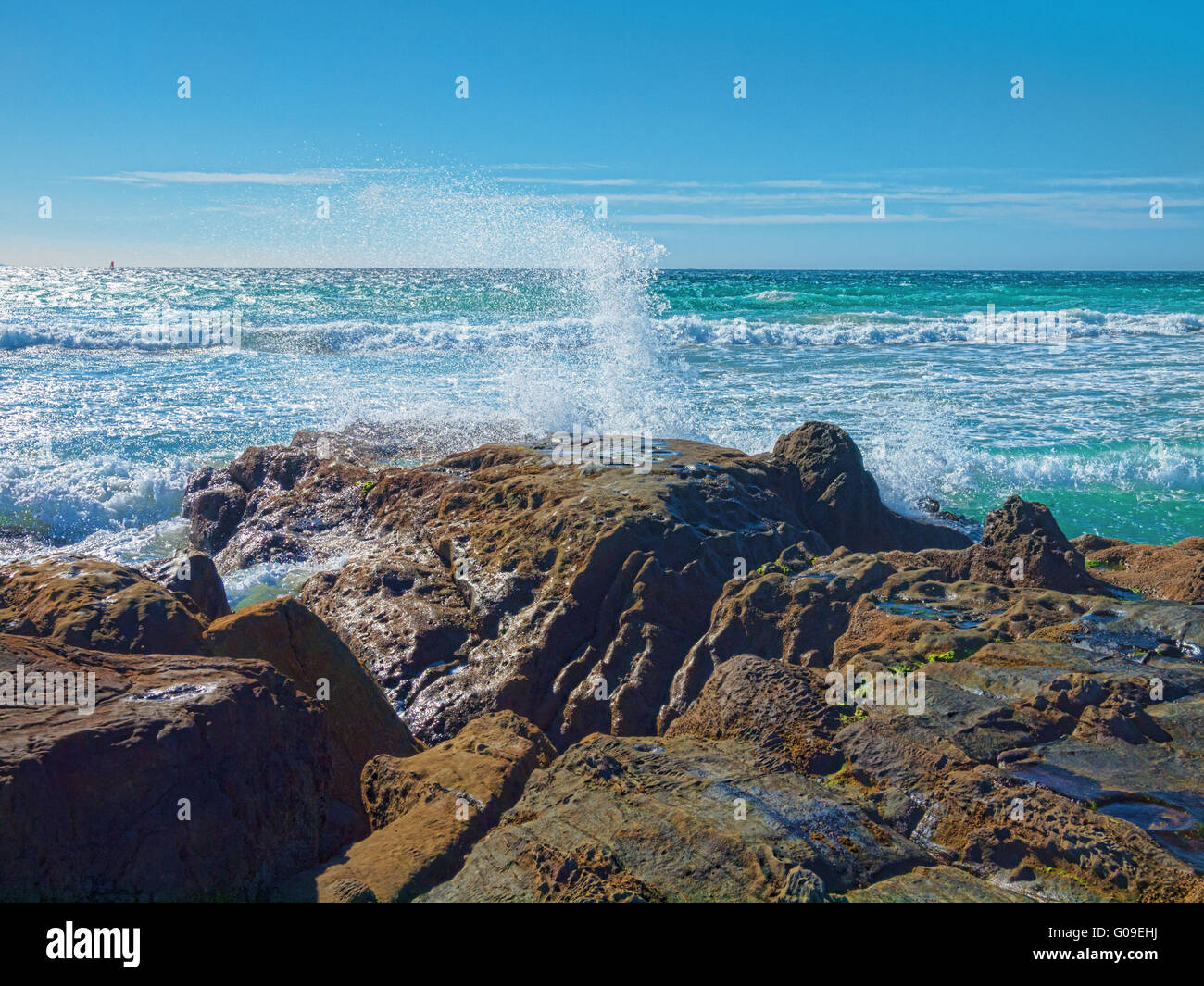 Waves breaking a rock background hi-res stock photography and images ...