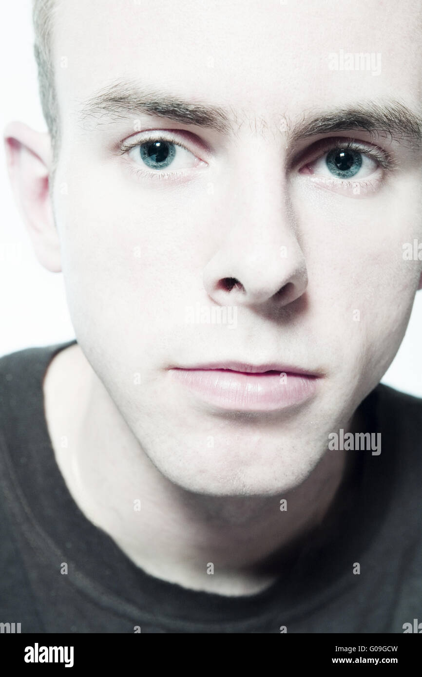 Studio portrait of a young man seriously looking Stock Photo - Alamy