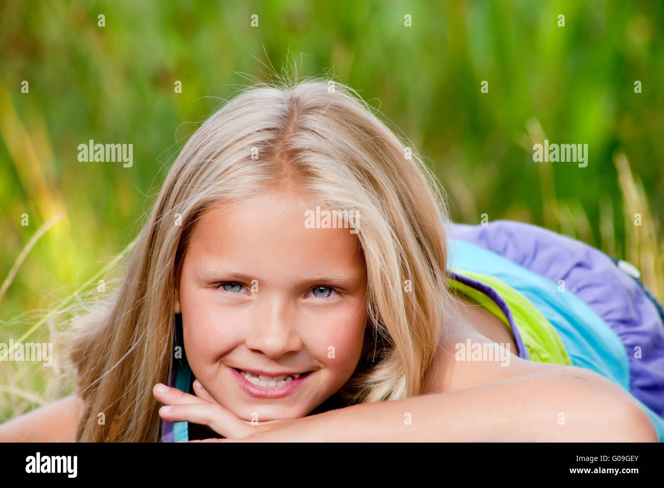 Smiling little blond girl Stock Photo - Alamy