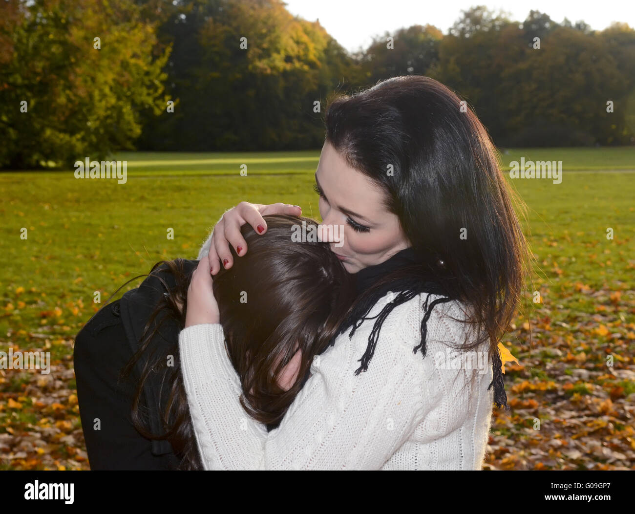 Two women hugging sad hi-res stock photography and images - Alamy