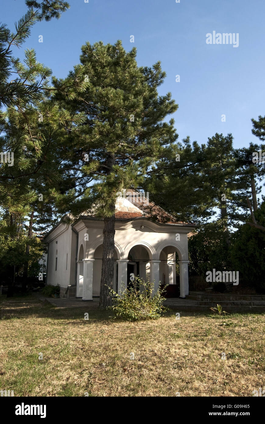 White chapel among trees in monastery courtyard Stock Photo - Alamy