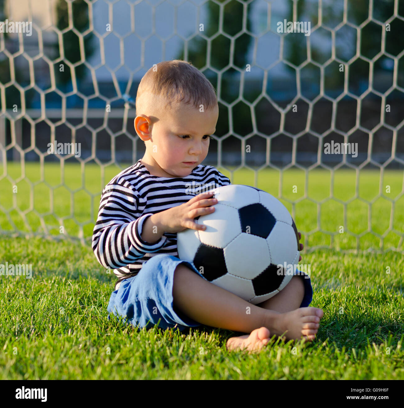Little boy in the goal with his soccer ball Stock Photo - Alamy
