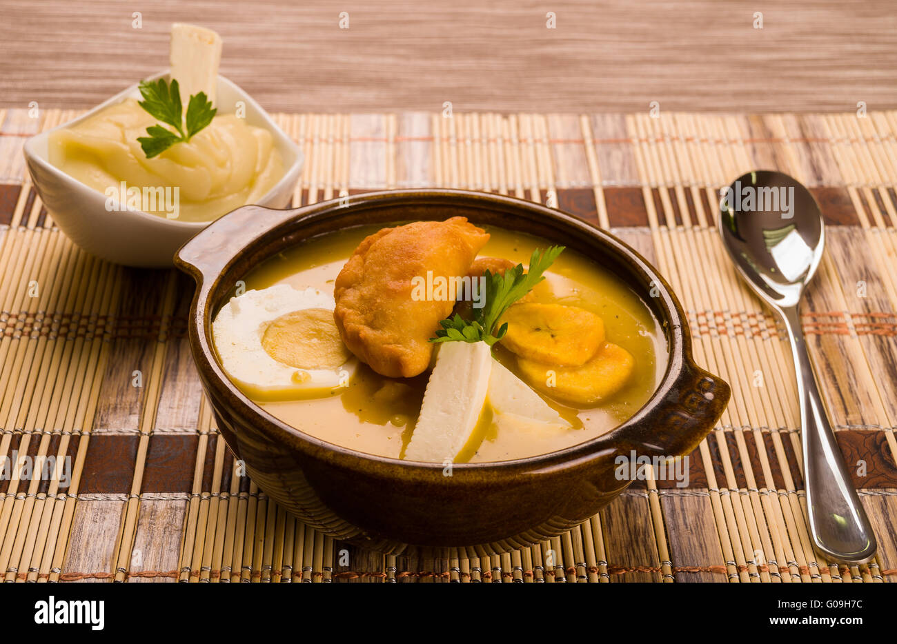 Elegant table setting with full serving of traditional fanesca soup and ...