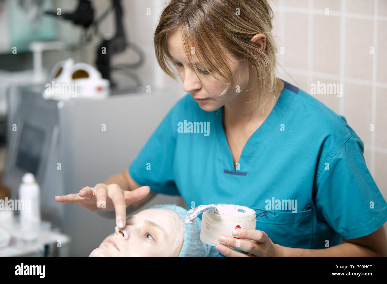 Nurse in a skin clinic applying protective cream Stock Photo - Alamy