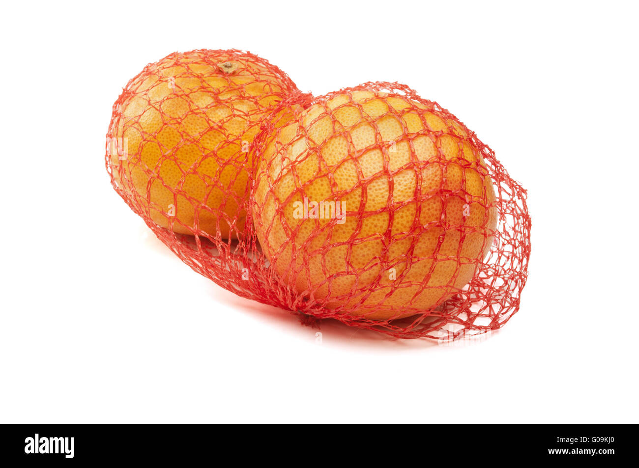 Net with fresh grapefruits on a white background Stock Photo - Alamy
