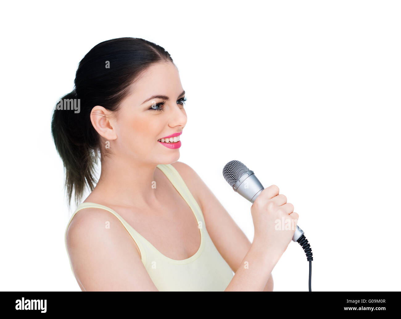 Beautiful young woman holding a microphone Stock Photo - Alamy