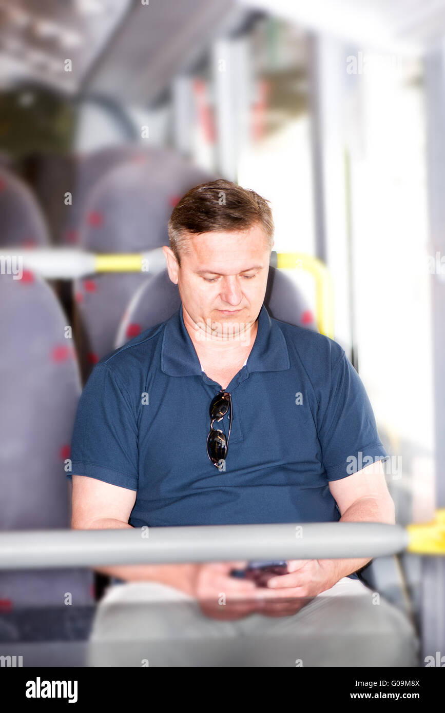 Man traveling on bus and using his smartphone Stock Photo - Alamy