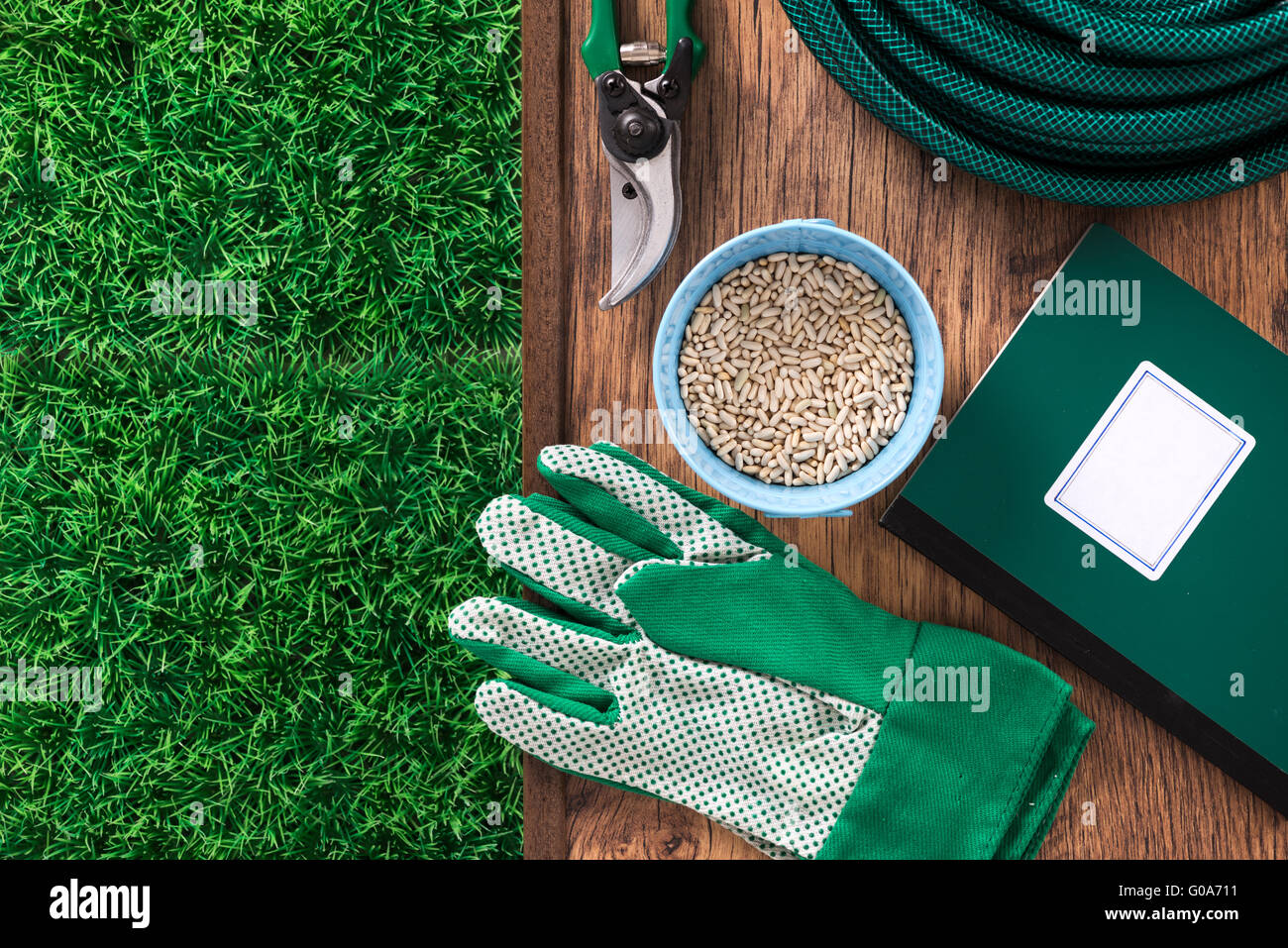 Farming and home gardening tools with green grass and farming manual ...