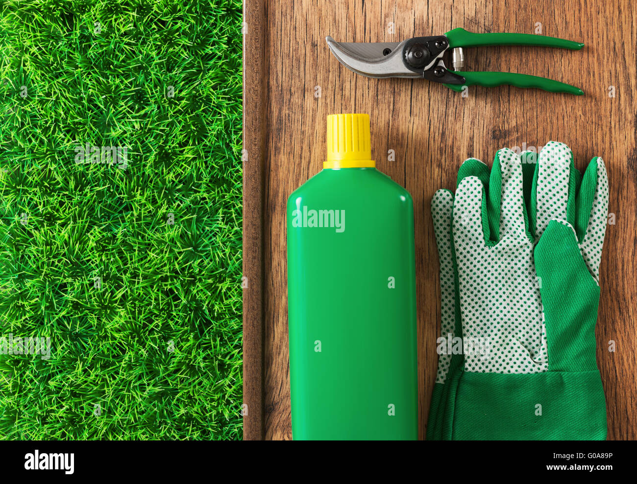 Gardener work table with grass, fertilizer and work tools, top view ...