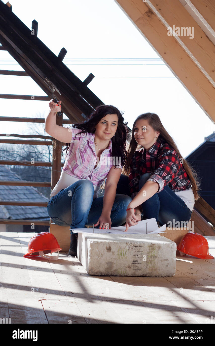 Two young women workers on the roof Stock Photo - Alamy