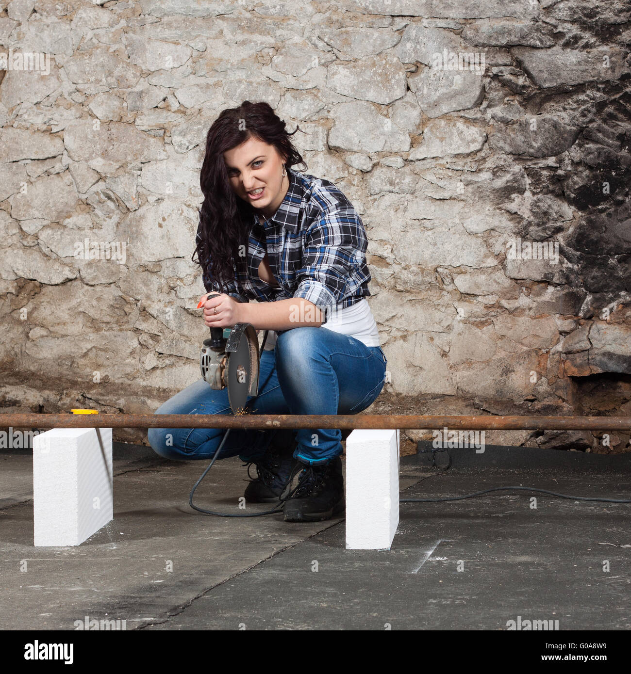 Young long-haired woman with an angle grinder Stock Photo - Alamy
