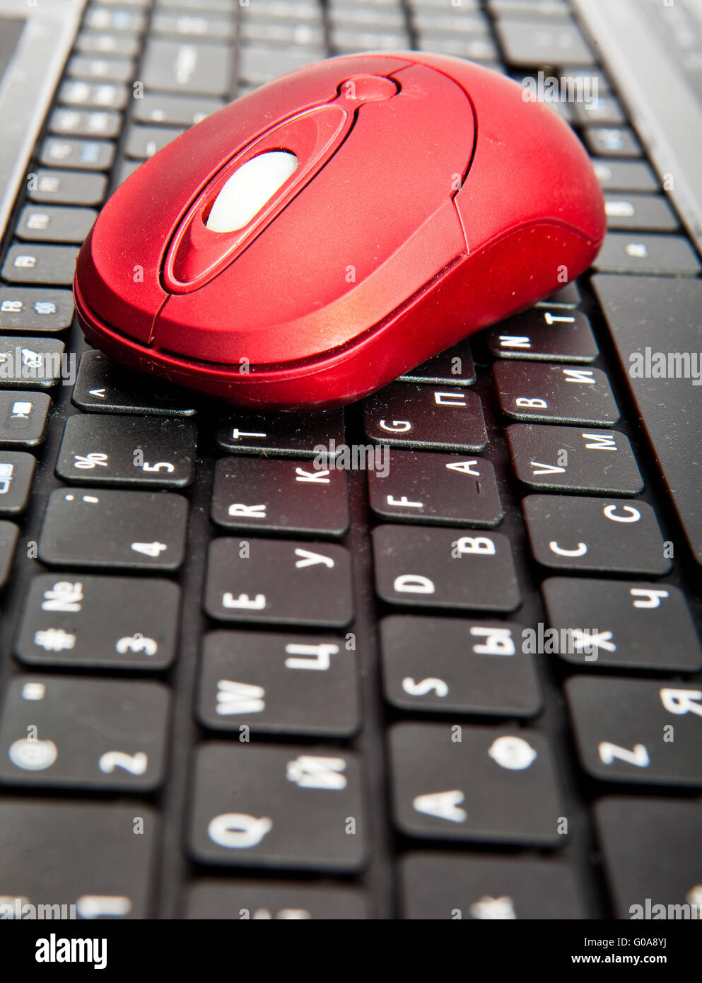 The red computer mouse on the black keyboard Stock Photo - Alamy