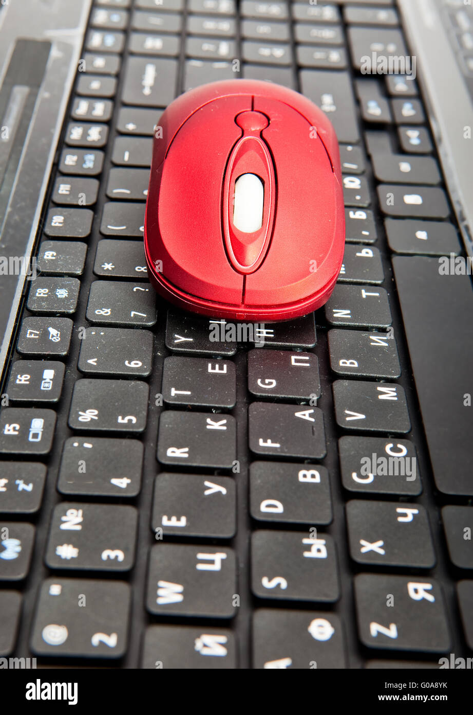 The red computer mouse on the black keyboard Stock Photo - Alamy