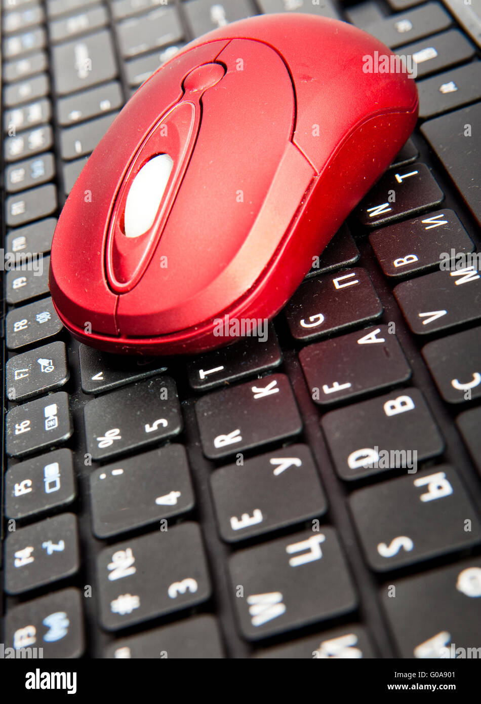 The red computer mouse on the black keyboard Stock Photo - Alamy