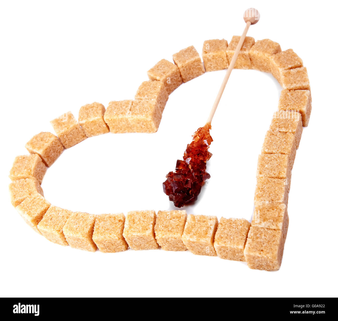 Heart from not refined reed sugar and candy sugar Stock Photo - Alamy