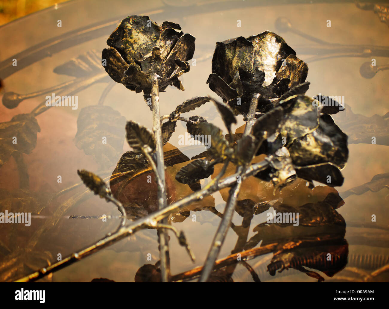 The shiny metal forged roses, handmade Stock Photo - Alamy