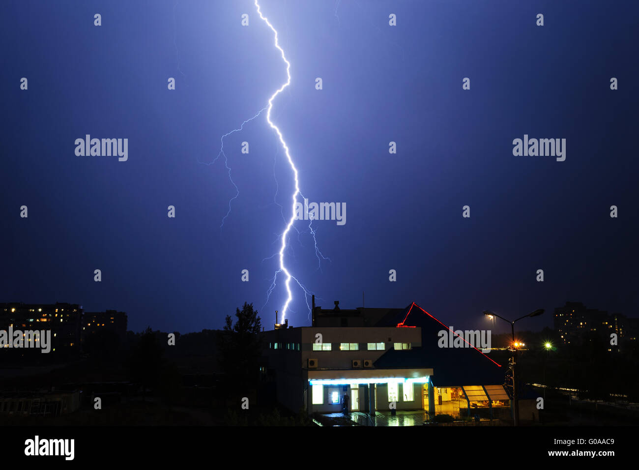 Severe lightning storm with rain over a city buildings at night Stock ...