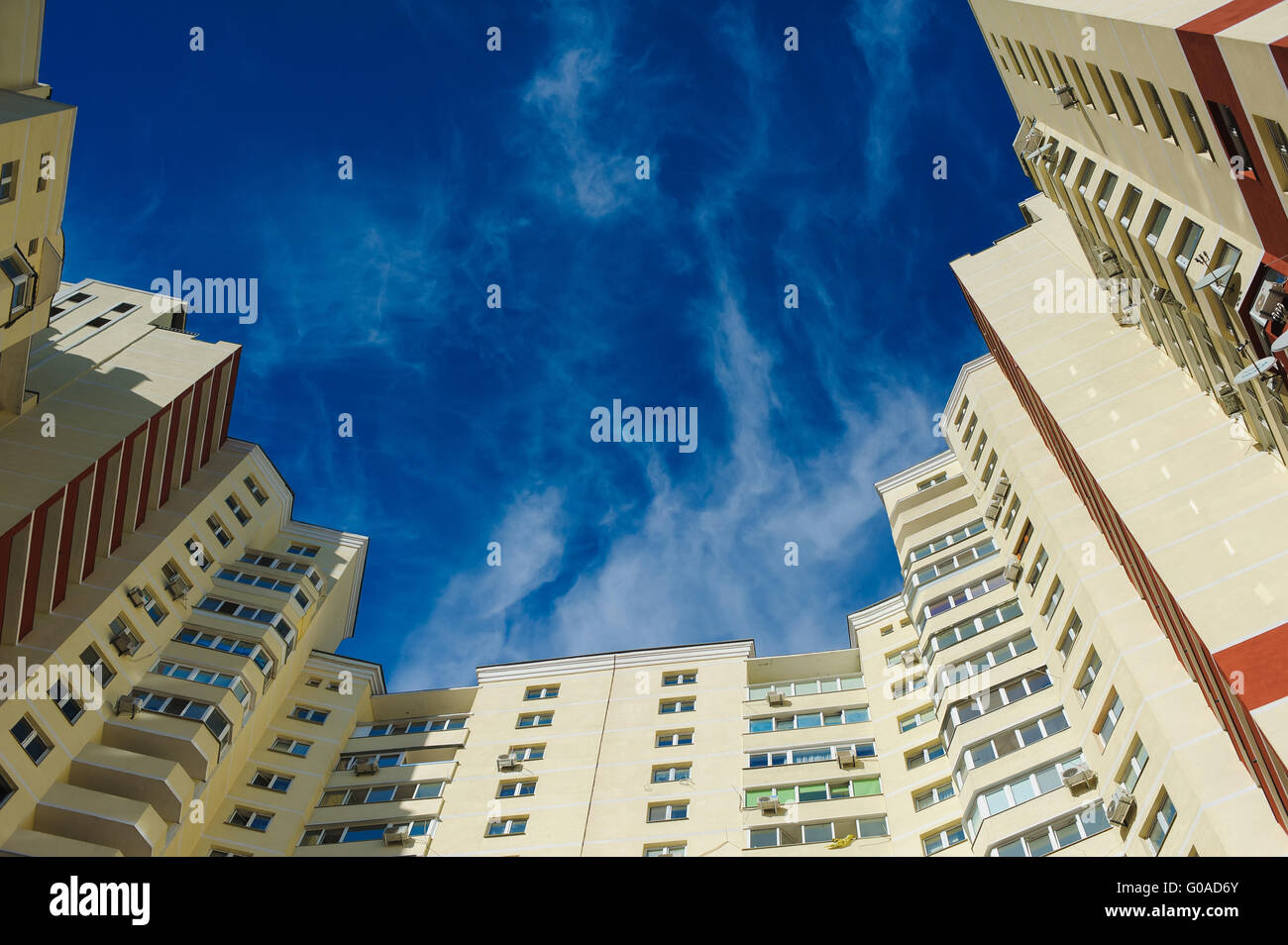 View at sky between apartment buildings Stock Photo - Alamy