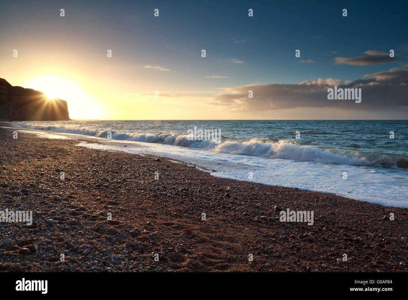 gold warm sunset over ocean waves Stock Photo - Alamy