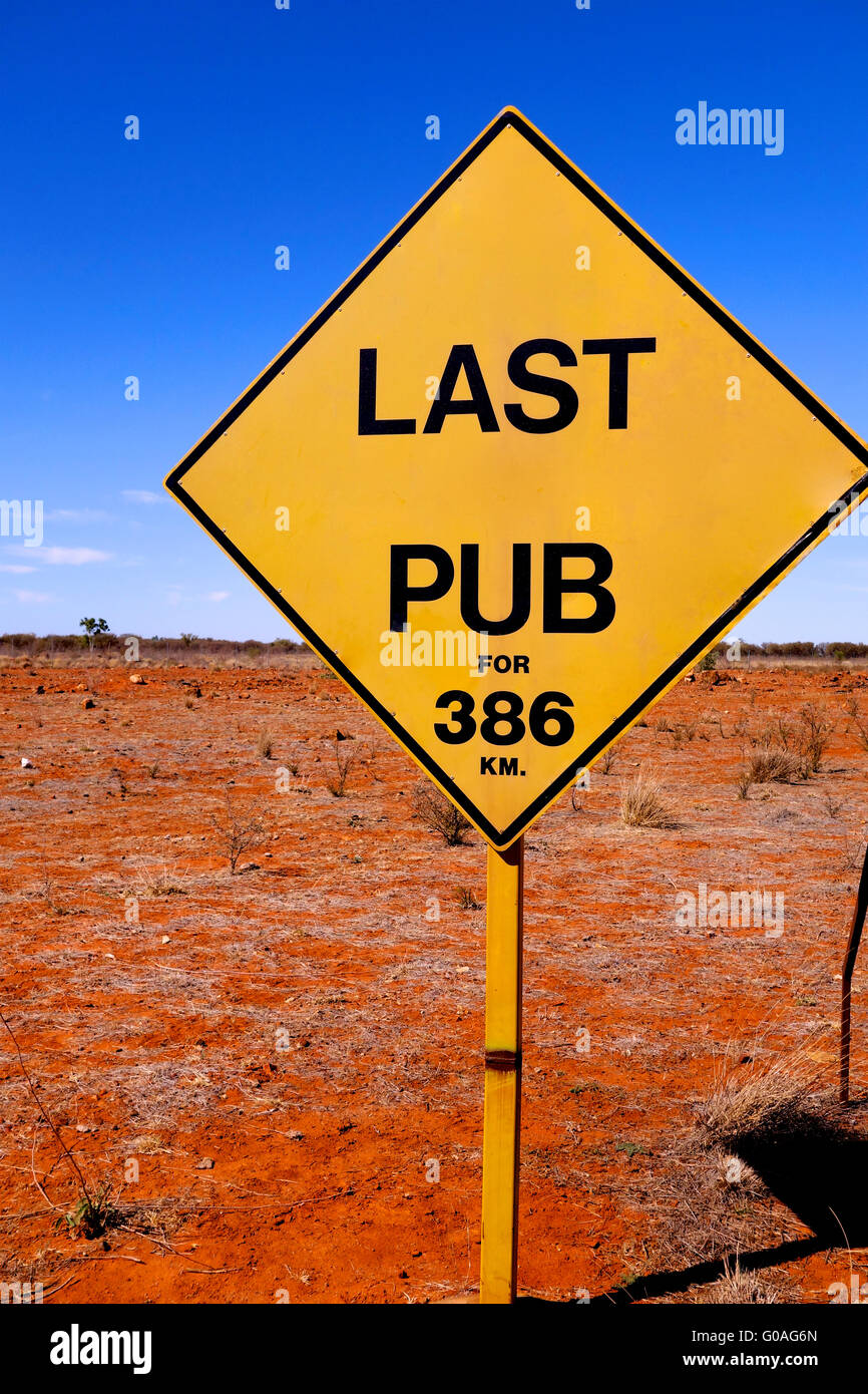 Last pub for 386klms sign, outback Australia Stock Photo - Alamy