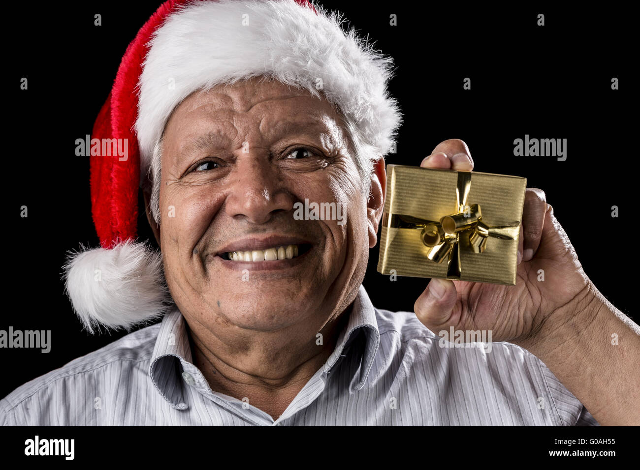 Old Gentleman With Red Hat Offering Golden Gift Stock Photo - Alamy