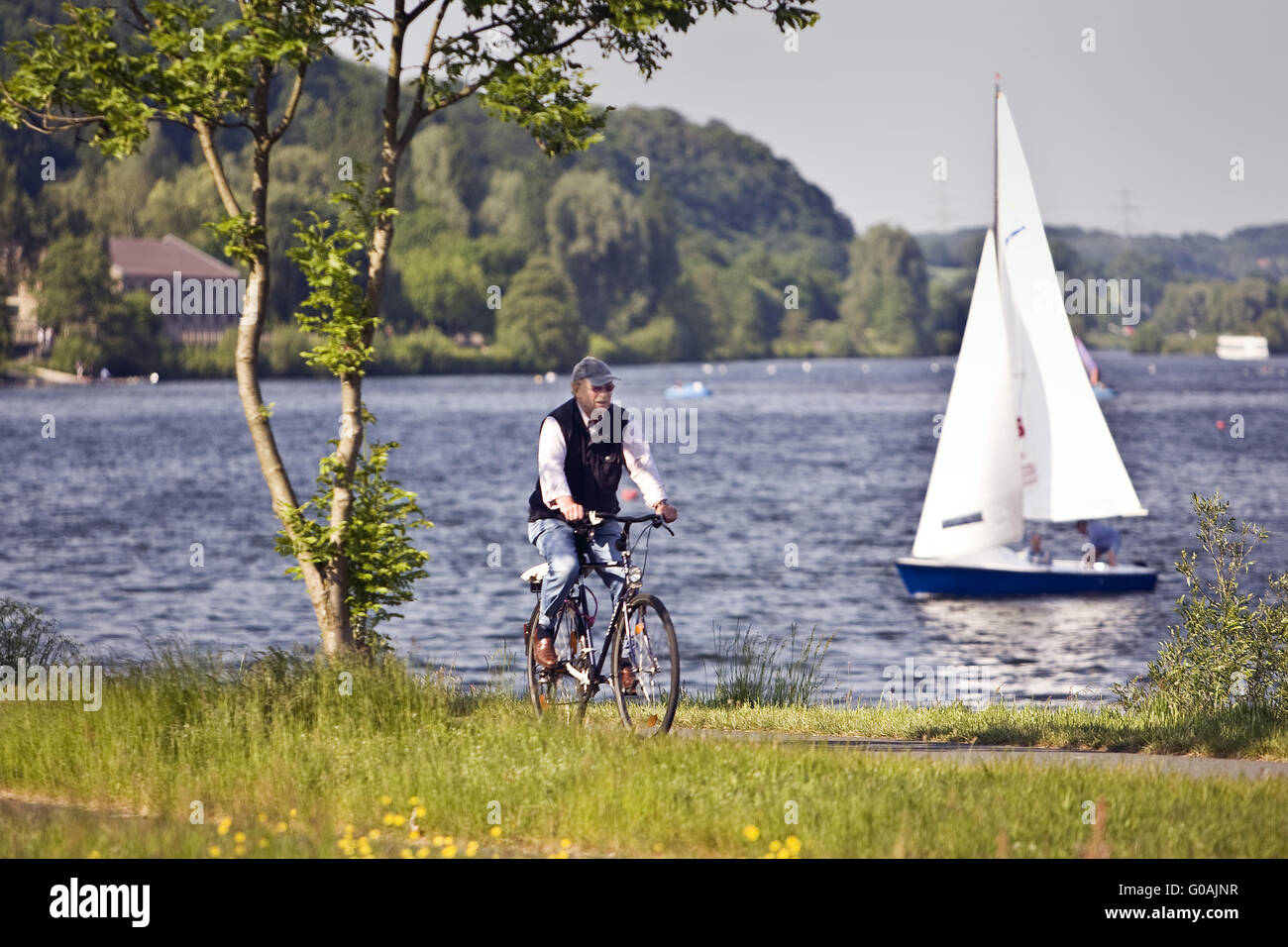 Cyclists and sailing boat, Lake Kemnade, Germany Stock Photo - Alamy