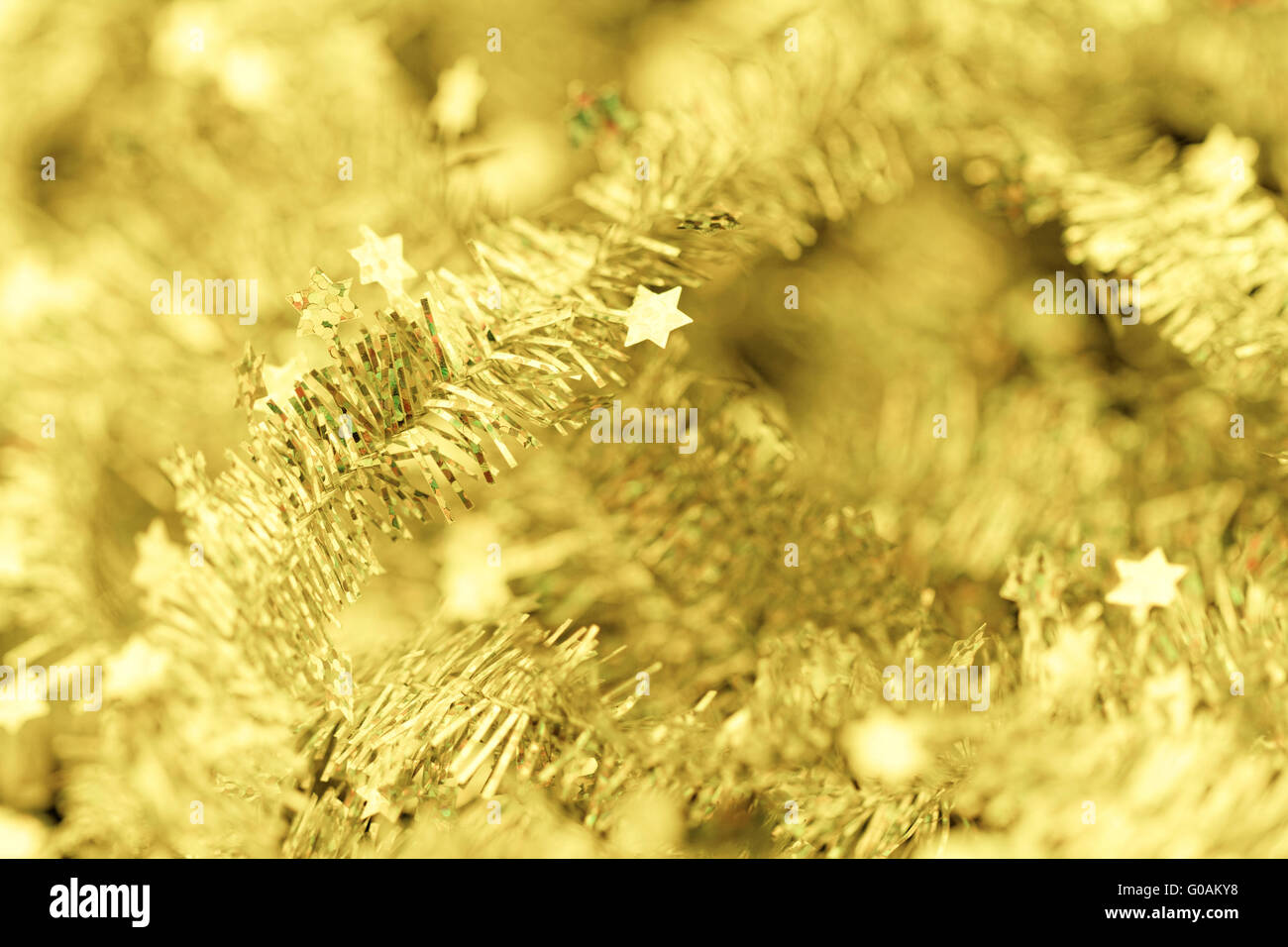 Golden tinsel Christmas decoration - close-up photo Stock Photo - Alamy