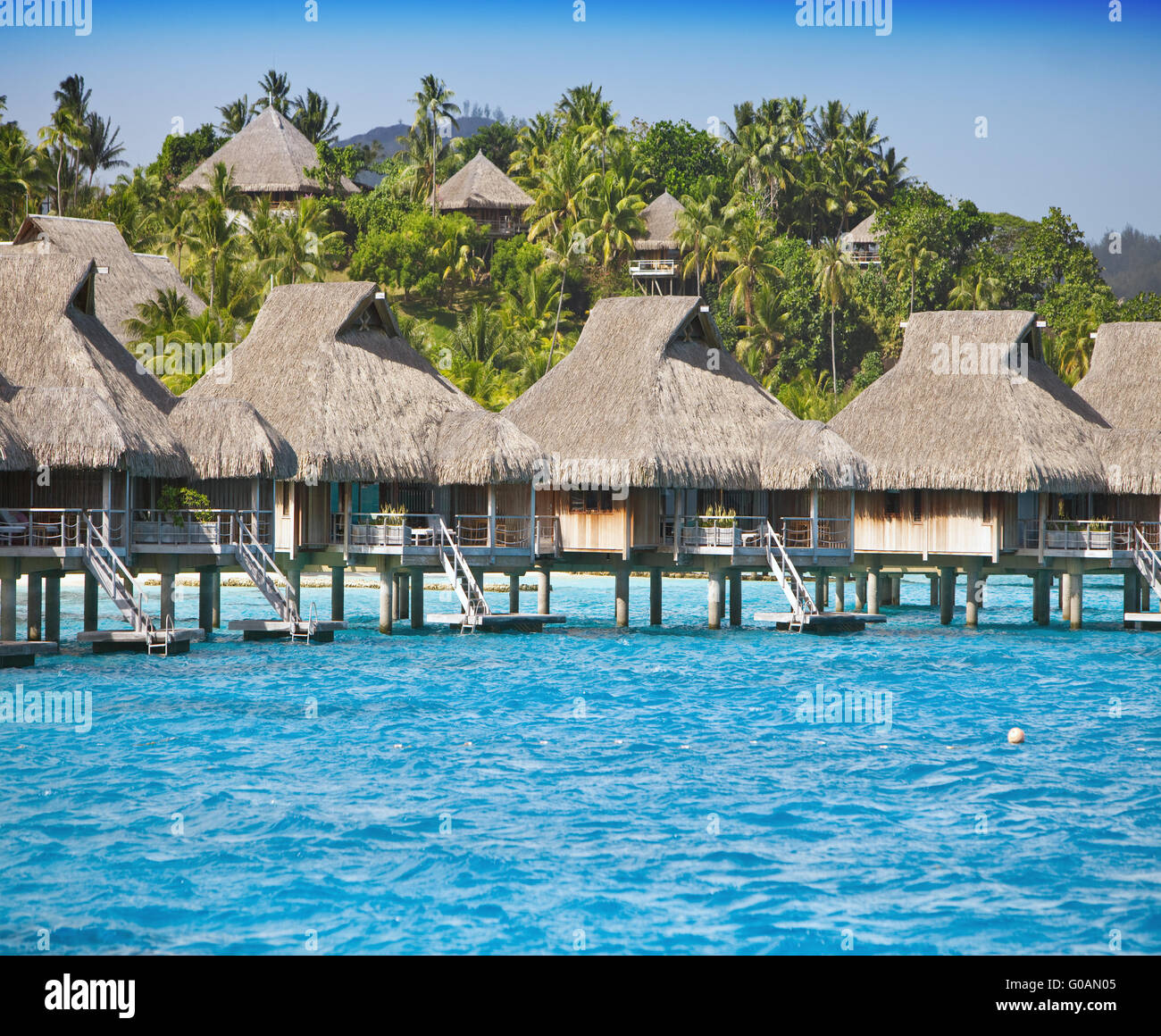 seacoast with palm trees and small houses on water Stock Photo - Alamy