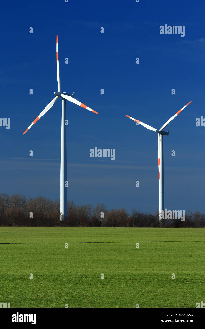 Wind mills on a green meadow Stock Photo - Alamy