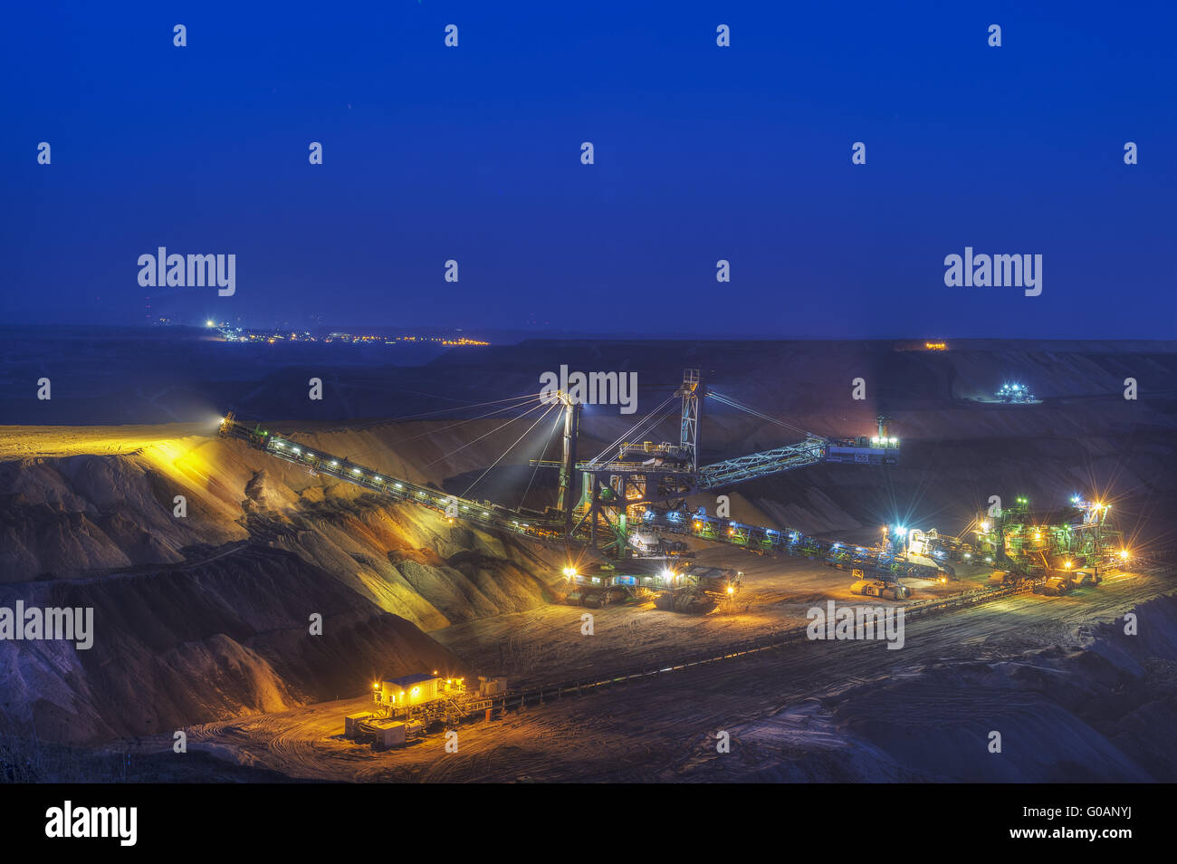Spreaders and conveyor in open pit mining, Night S Stock Photo - Alamy