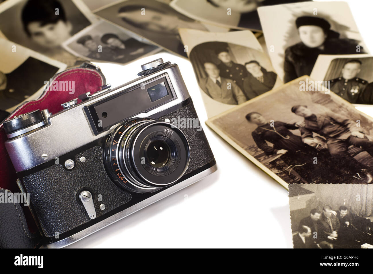 The old film camera and ancient photos on a white Stock Photo - Alamy