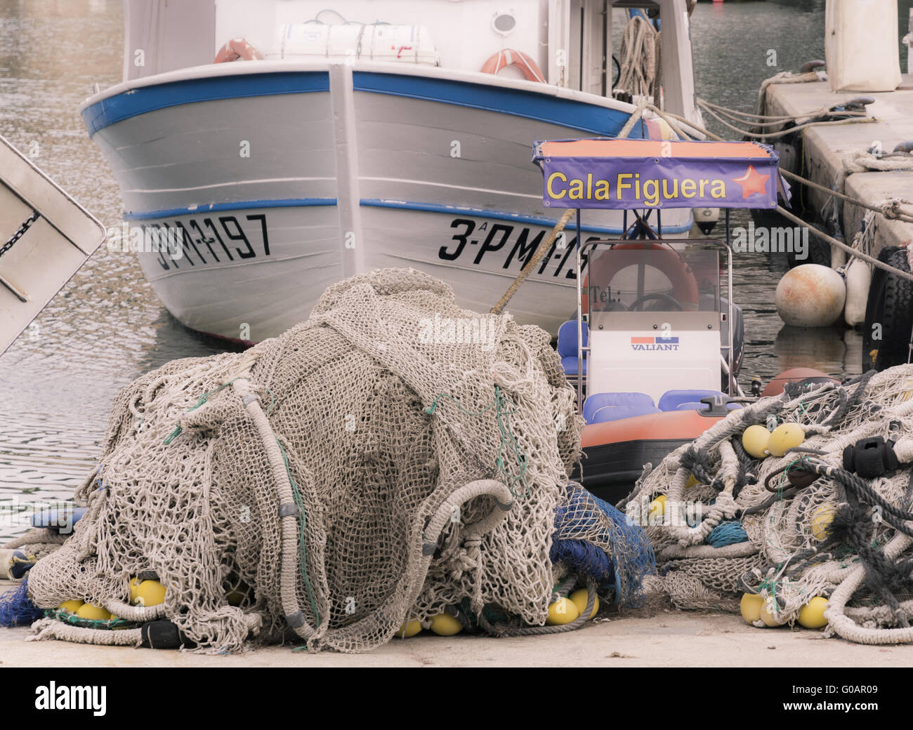 Cala Figuera fishnets and fishing boat in port Stock Photo - Alamy