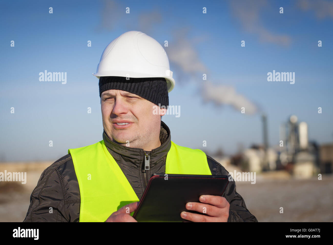 Engineer with tablet PC near the factory Stock Photo - Alamy