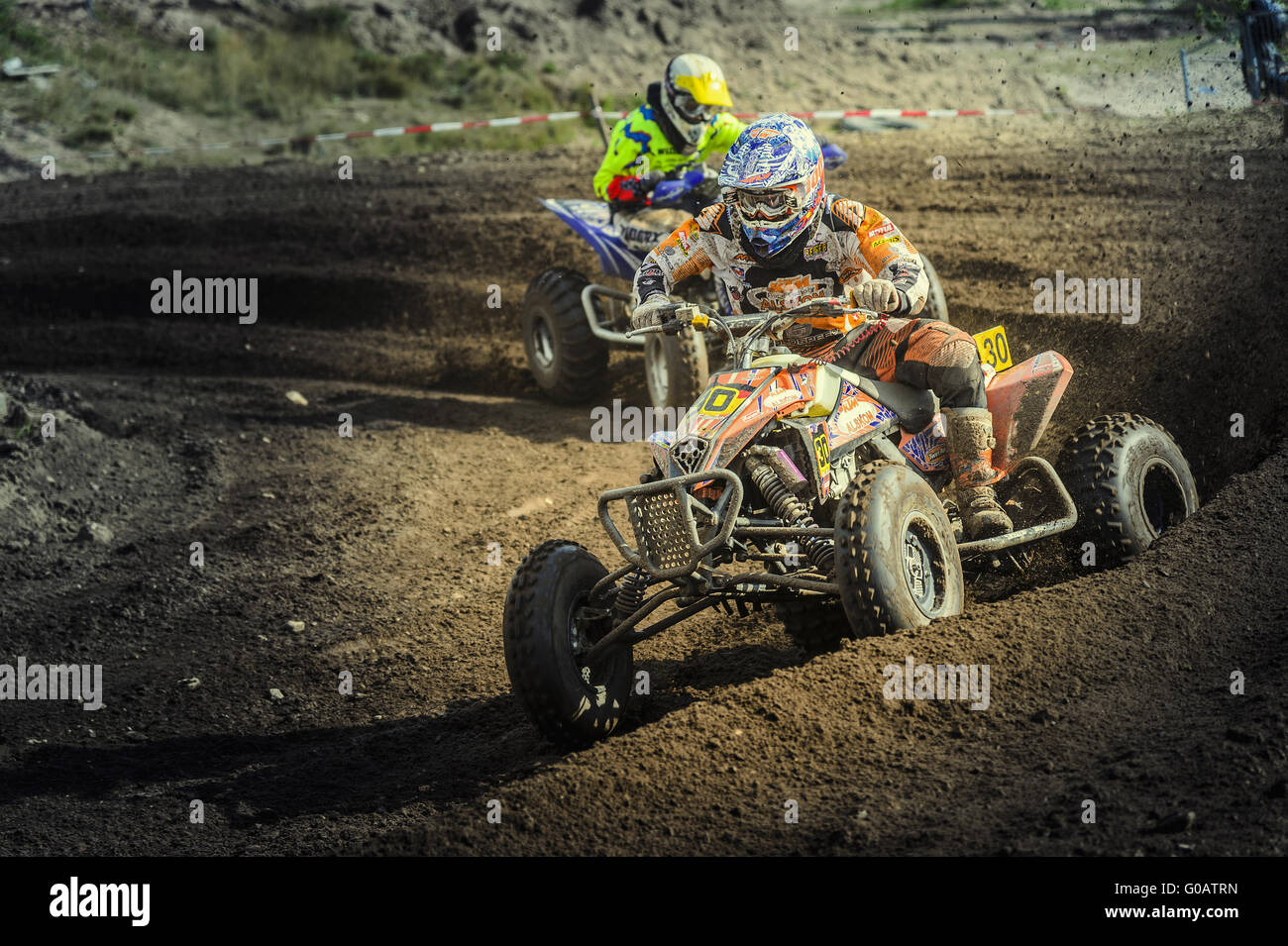 2 quads drive through a curve on the cross track Stock Photo - Alamy