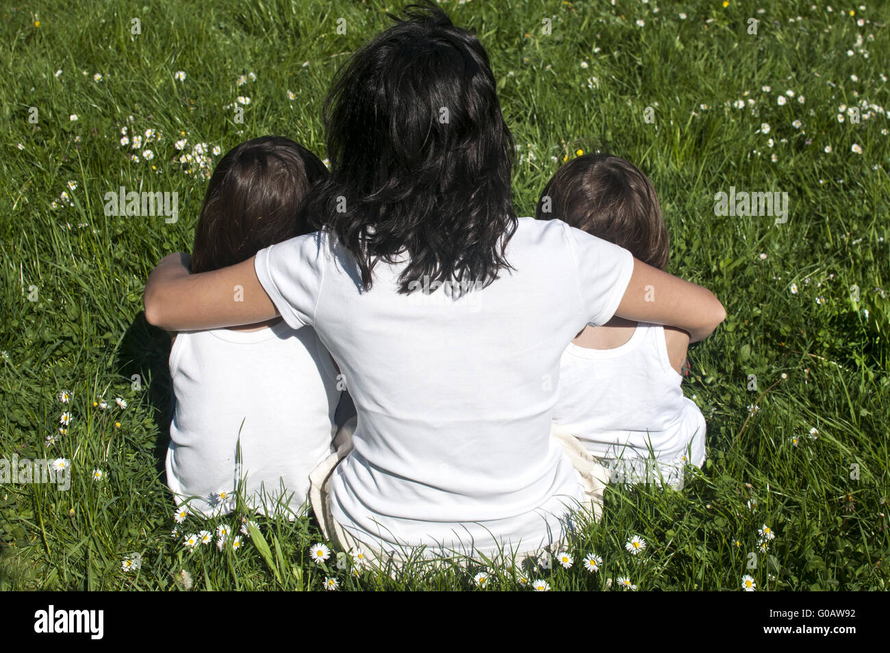 Mother with two children sitting back on spring me Stock Photo - Alamy