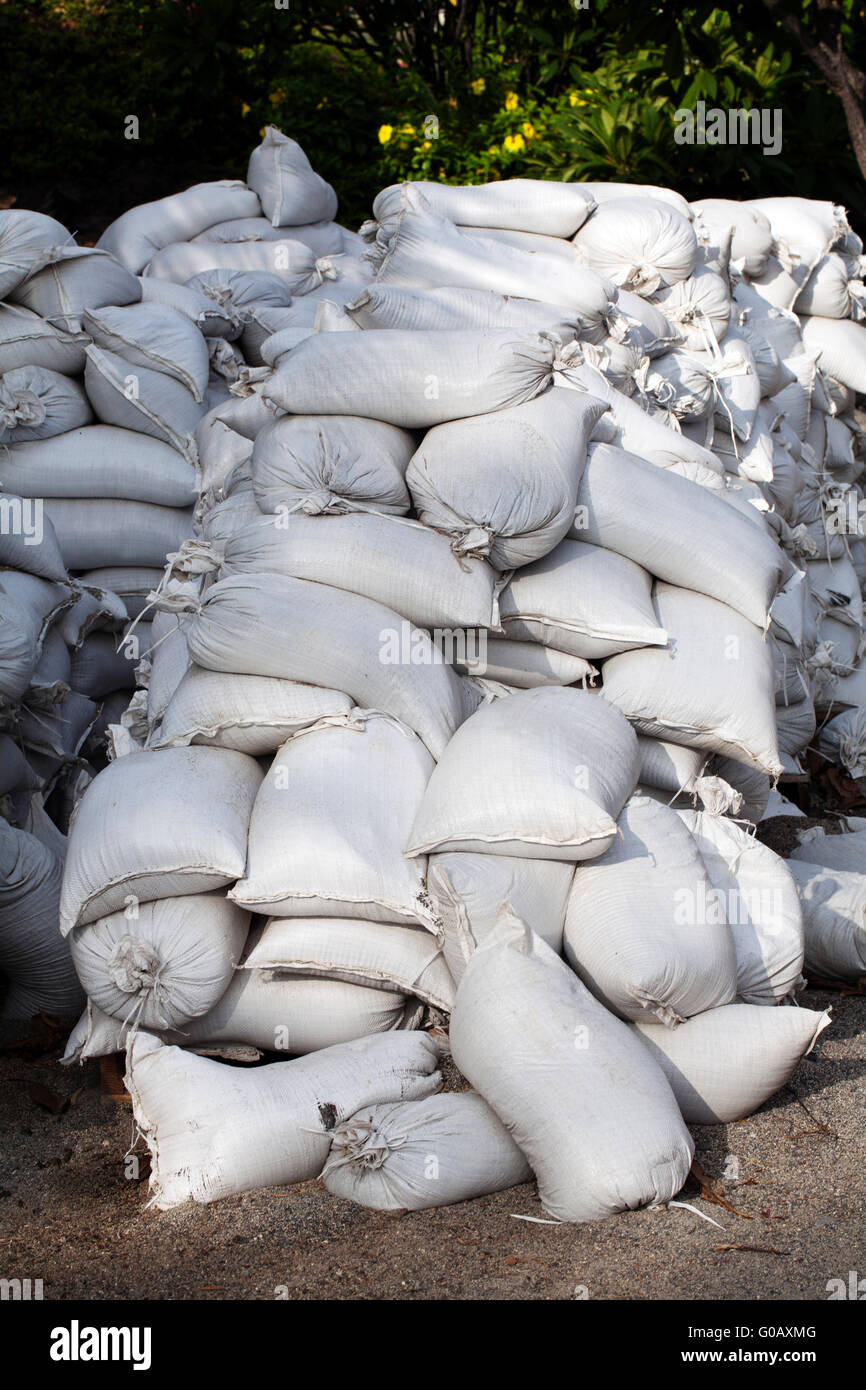 White cloth sand bags piled for flooding control Stock Photo - Alamy