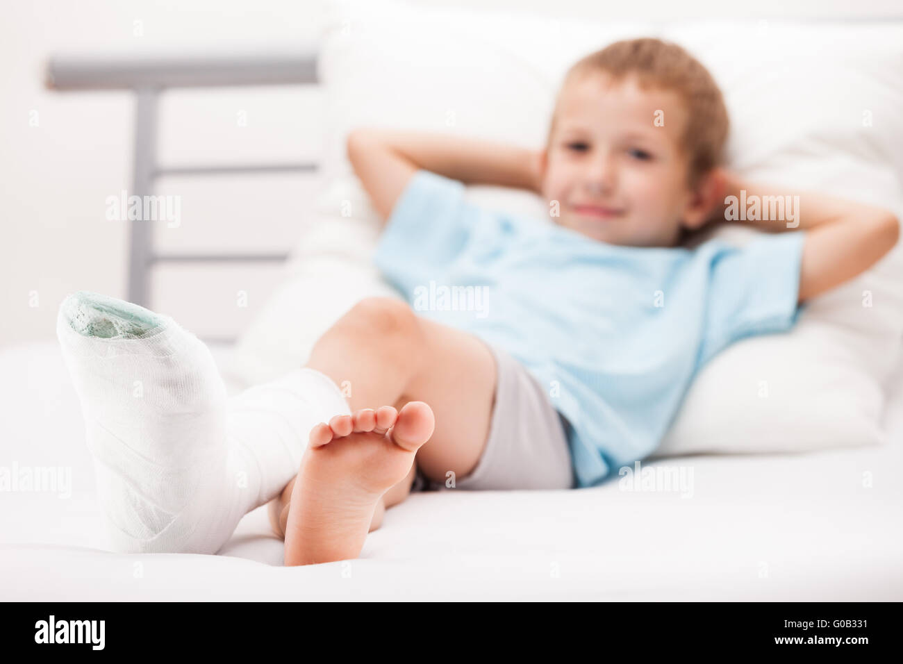 Little child boy with plaster bandage on leg heel Stock Photo - Alamy