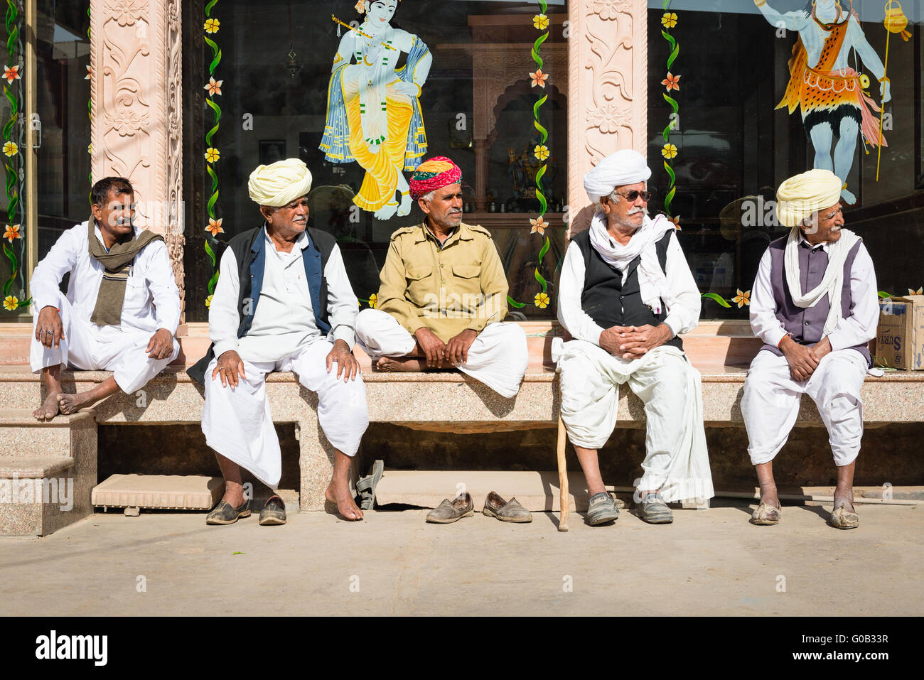 Group of men sitting outside a Hindu temple in an Indian village Stock ...