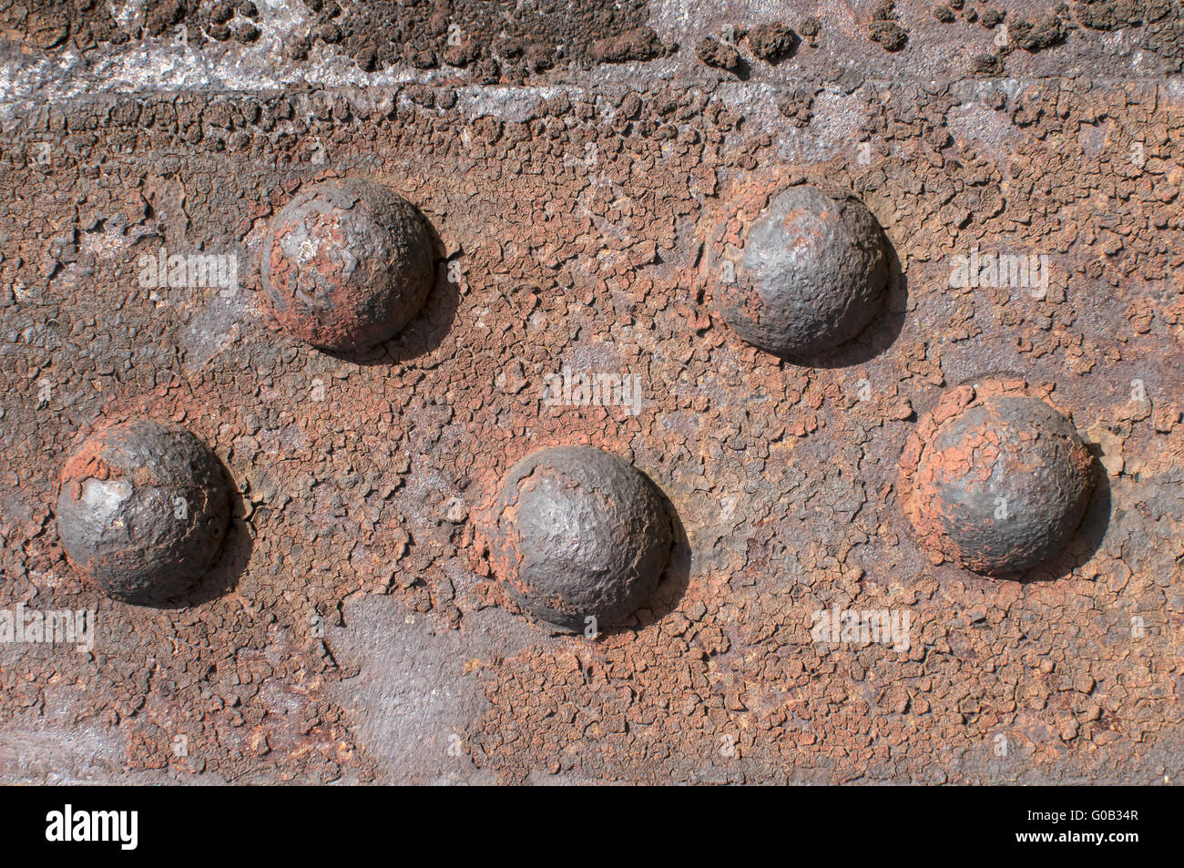 Weathered rusty iron element with centennial rivet Stock Photo - Alamy