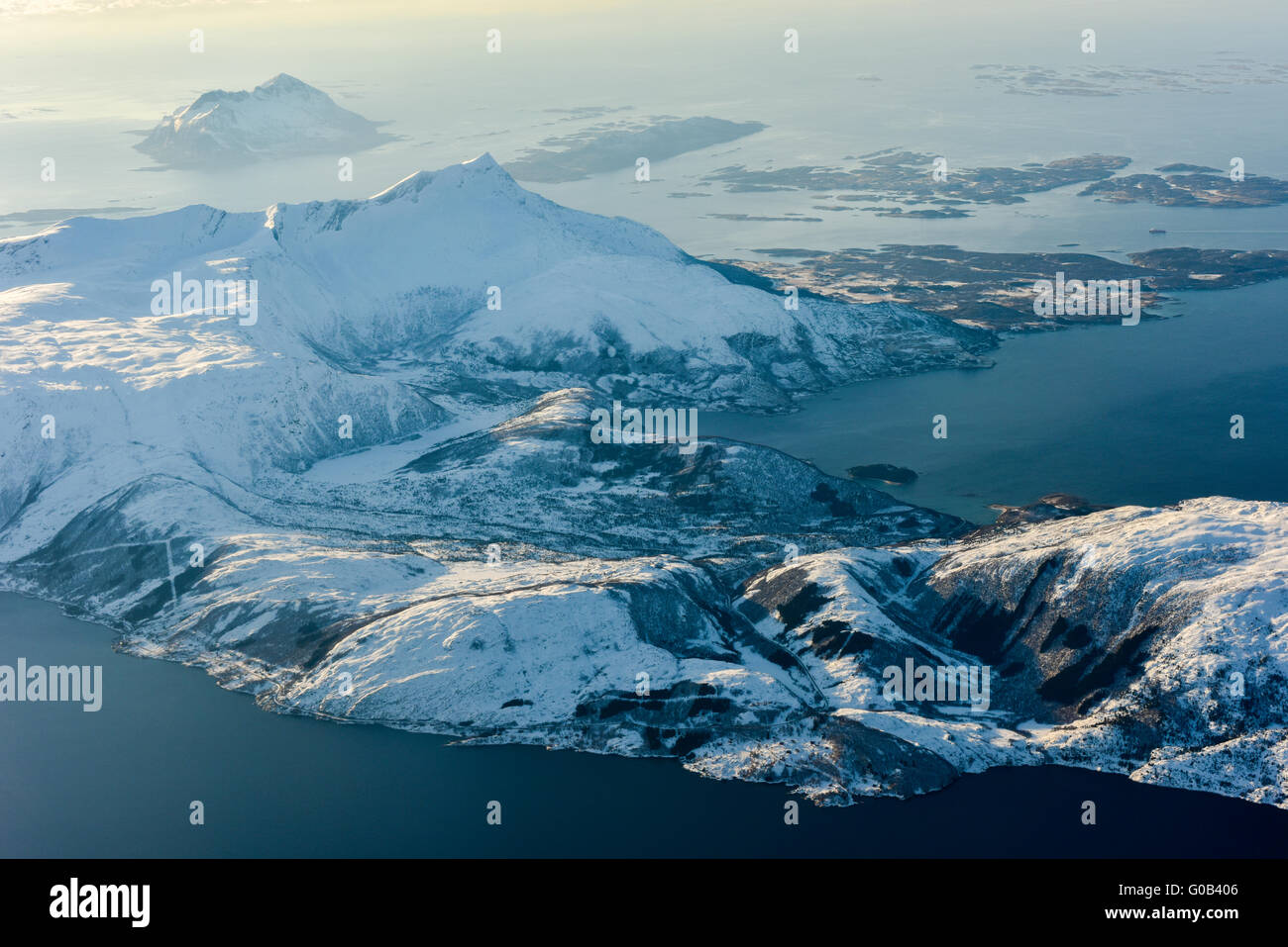 An aerial view of the snow covered mountains of the fjords of Norway in ...